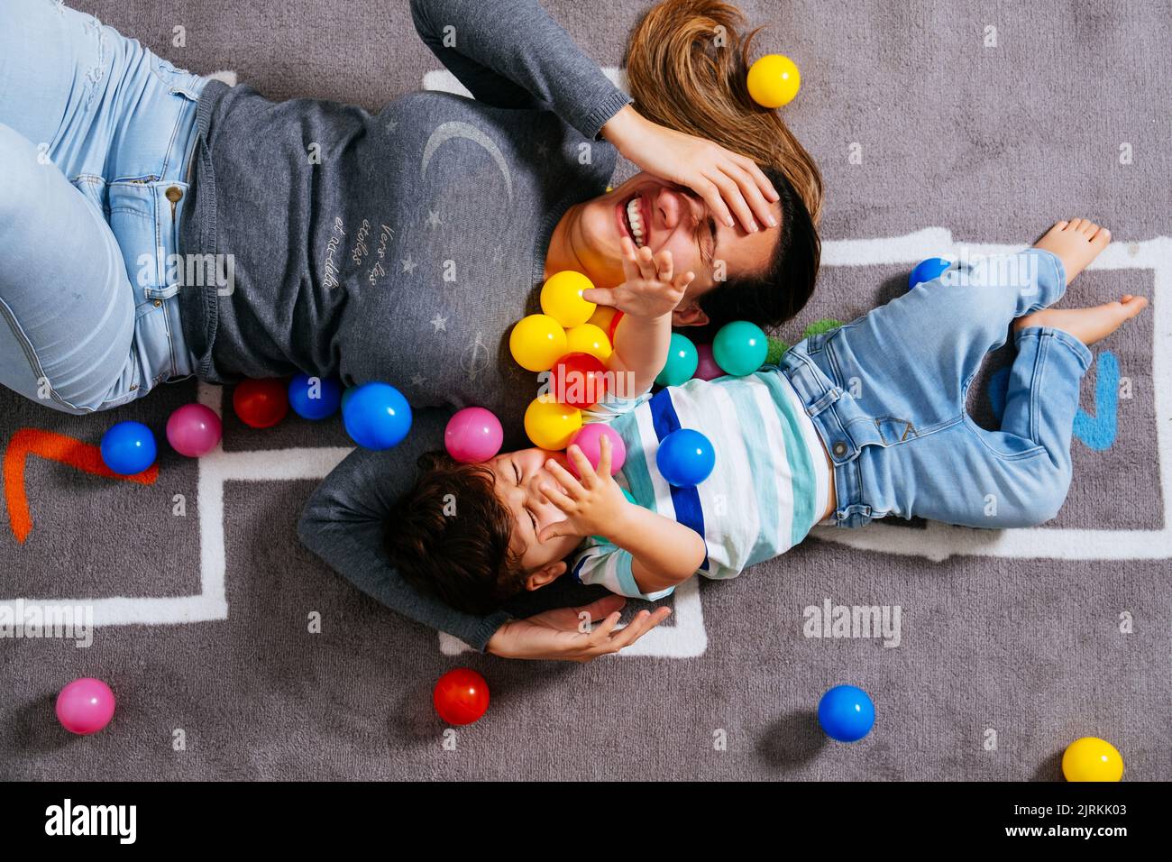 From above delighted woman and little boy screaming and throwing ...