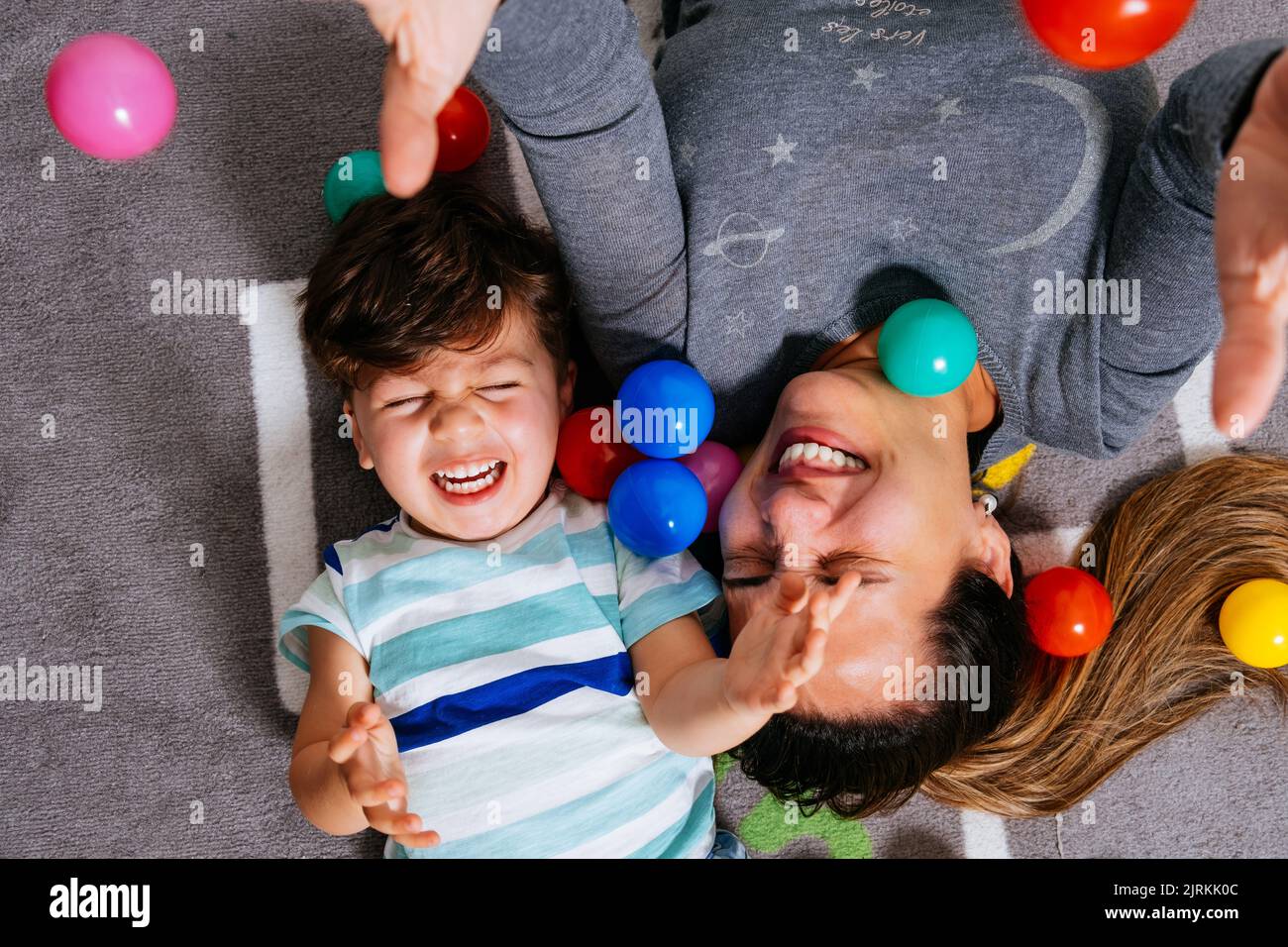 From above delighted woman and little boy screaming and throwing ...
