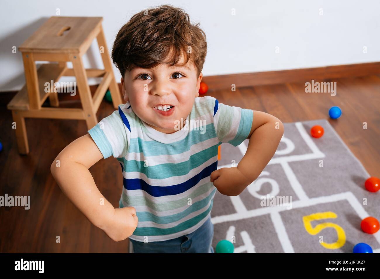From above astonished little boy screaming and clenching fists while ...