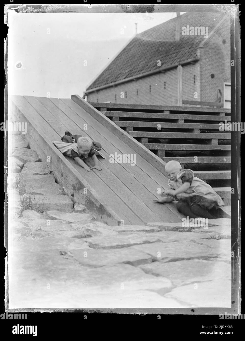 Two children sliding down a ramp hi-res stock photography and images ...