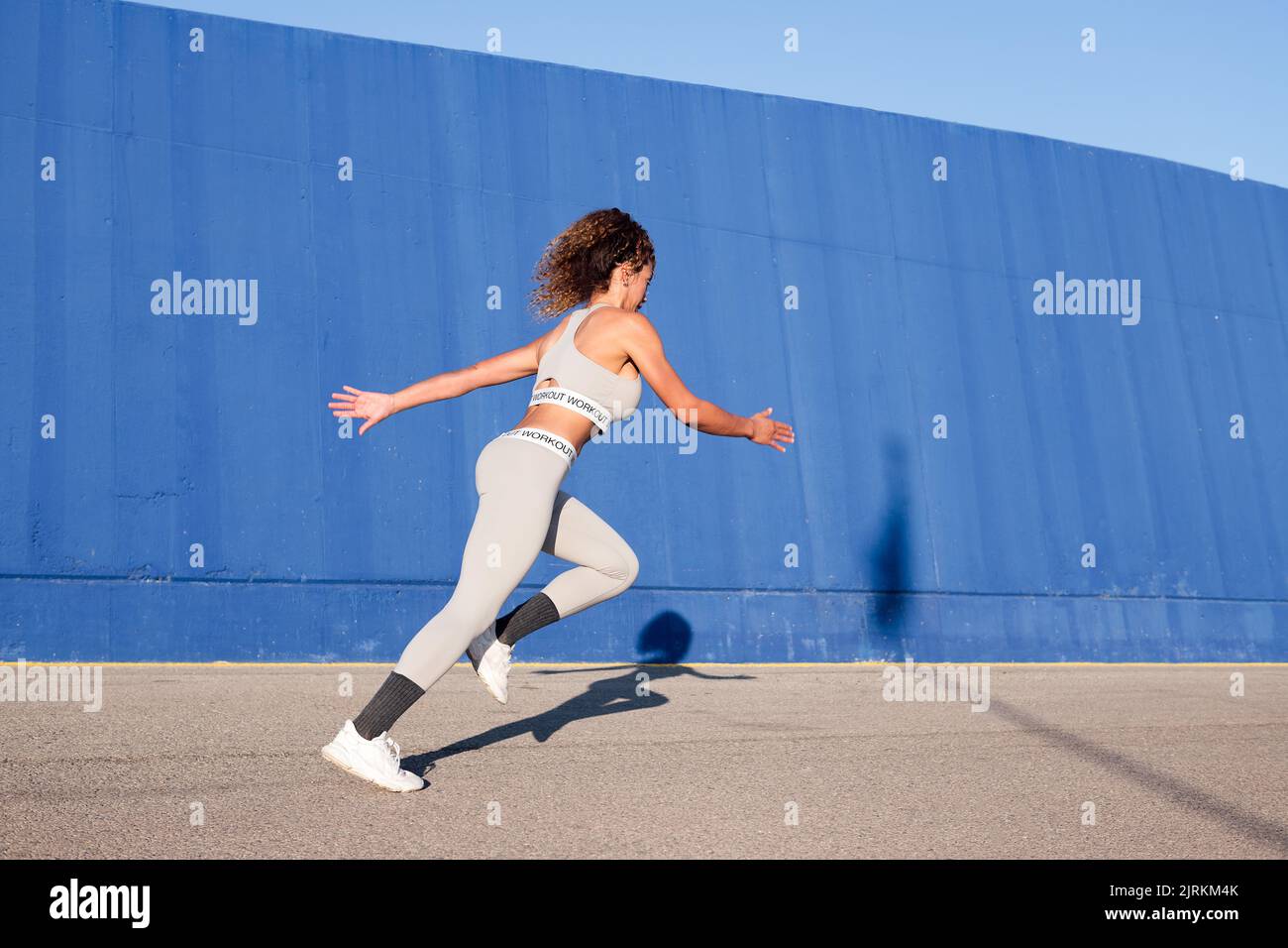 Woman sprinting in the curve hi-res stock photography and images - Alamy