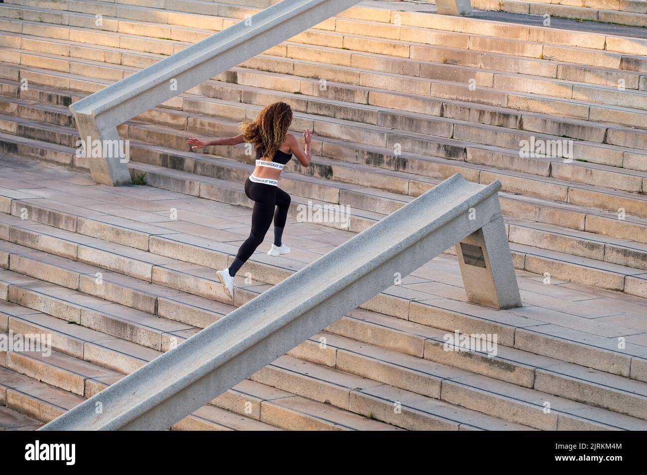 High angle side view of unrecognizable fast runner in activewear ...