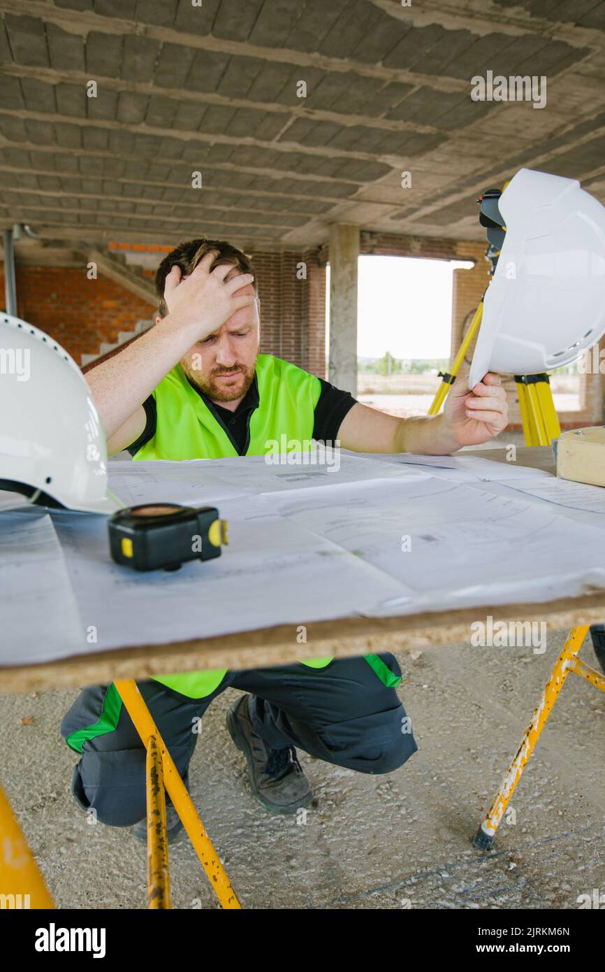 Surveyor engineer working at construction site with measuring equipment ...