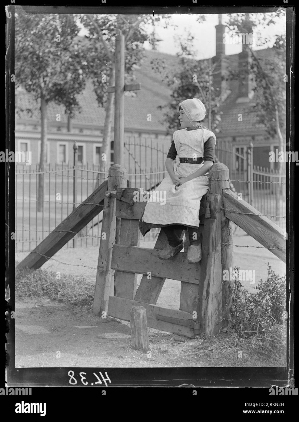 The netherlands girl sitting on gate Black and White Stock Photos ...