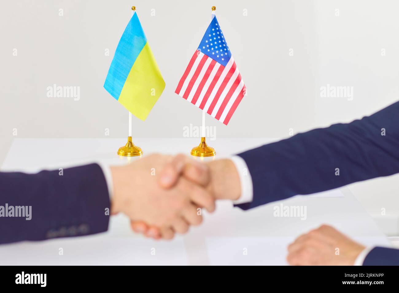 Diplomats from Ukraine and USA exchange handshakes after negotiating ...
