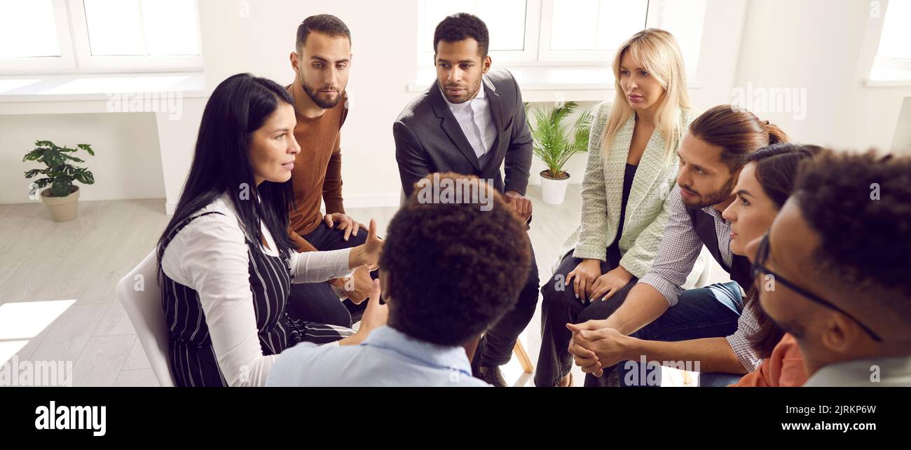 Business coach speaking about teamwork during meeting with group of ...