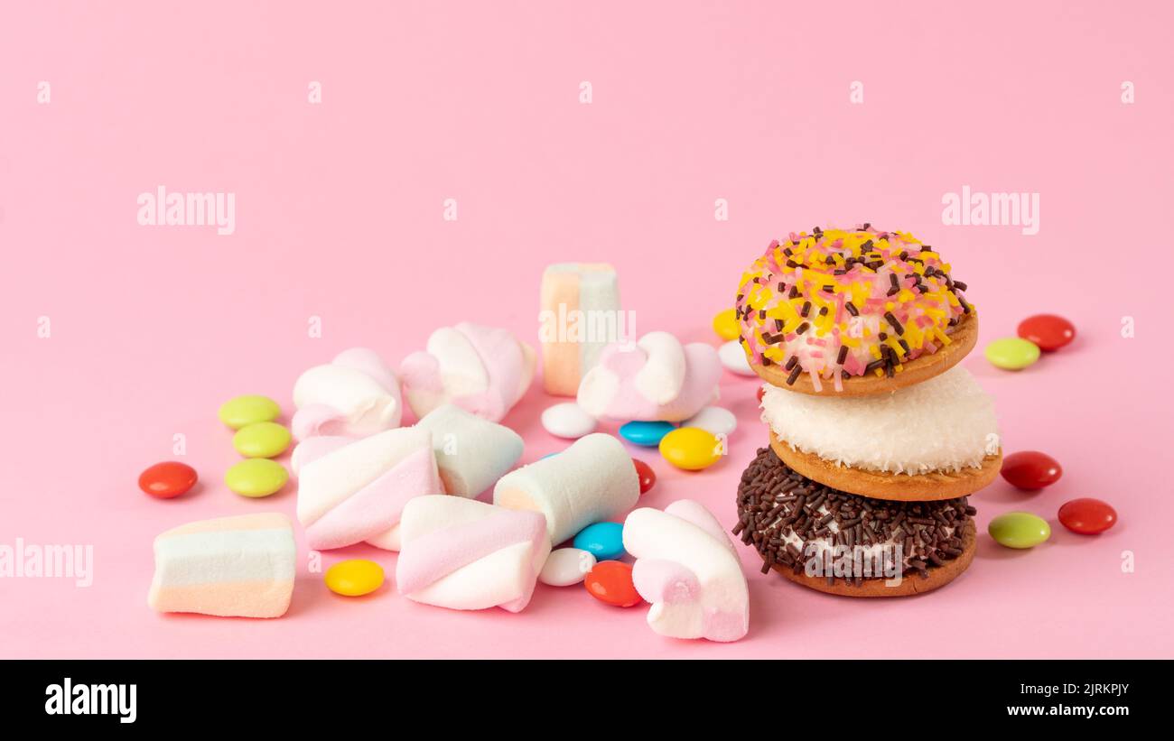 Sweets - cake, sweets, dragees, marshmallows on a pink background Stock ...