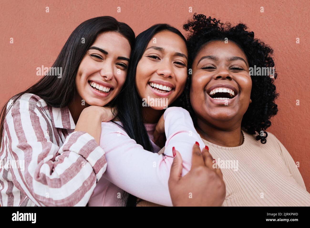 Latin girls having fun and hugging each others outdoor - Focus on faces ...