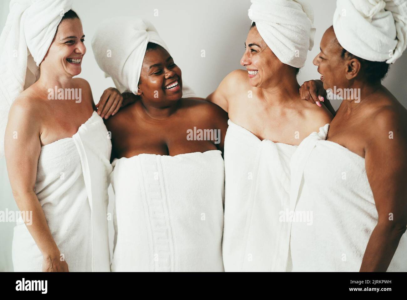 Multi-generational women with diverse skin and body laughing together ...