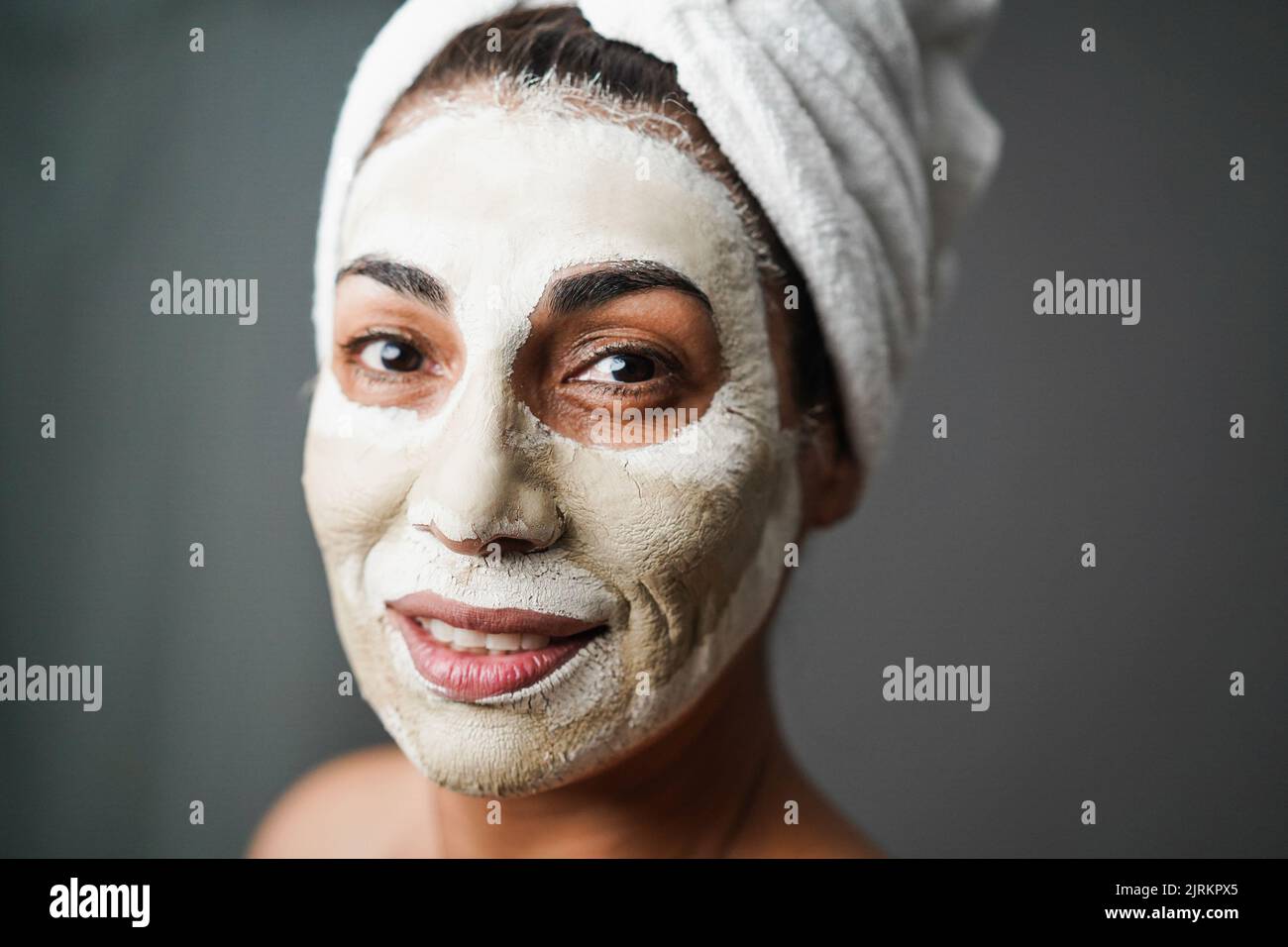 Senior woman doing beauty treatment using beauty skin mask - Main focus ...