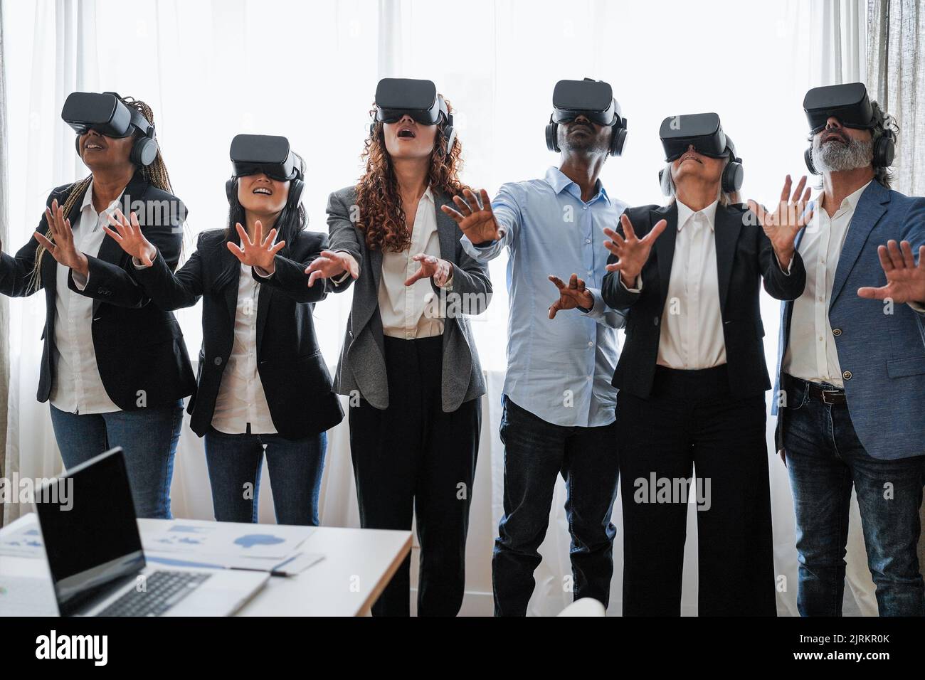 Multiracial business people wearing vr goggles inside office - Focus on ...