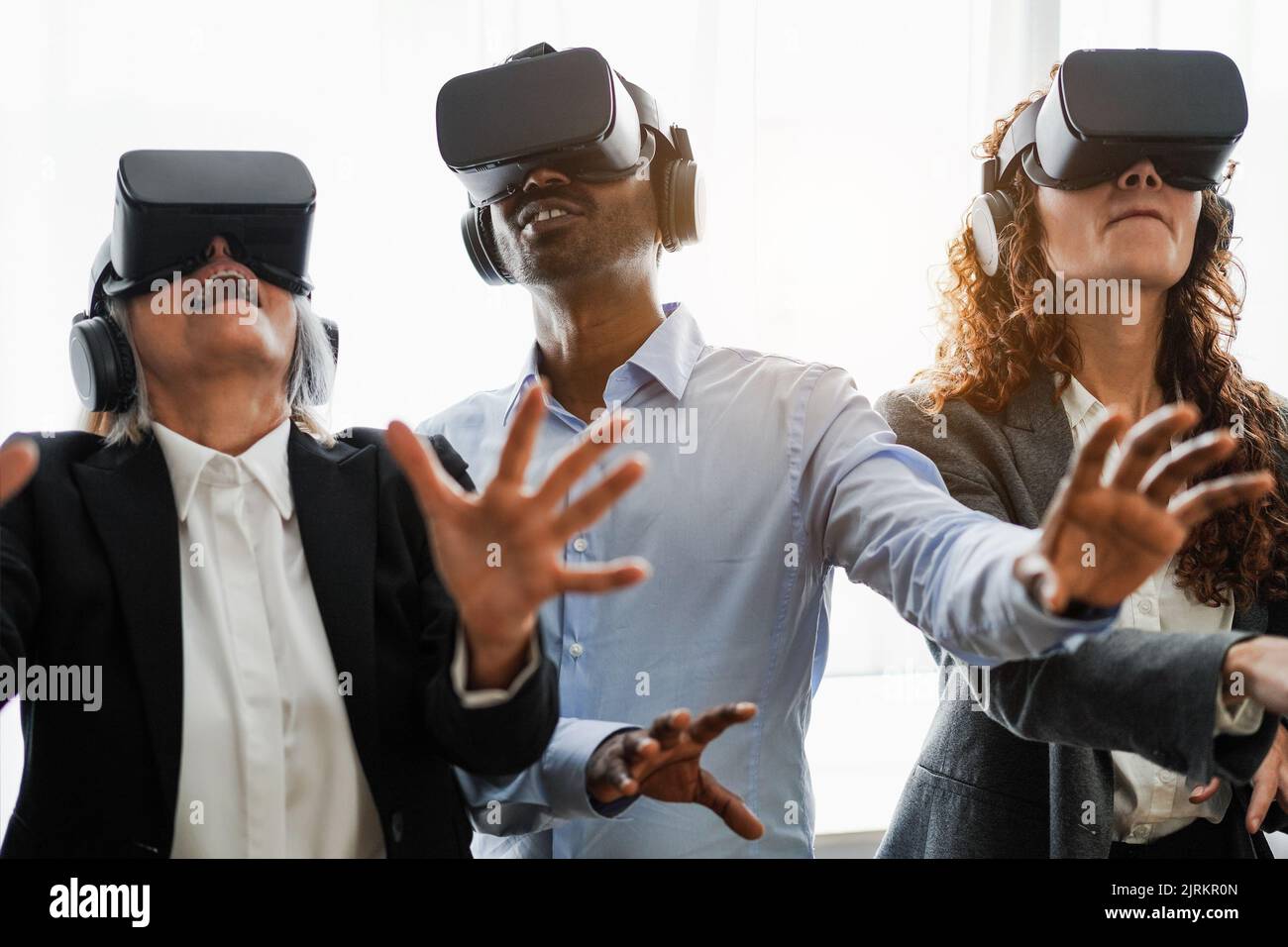 Multiracial business people wearing vr goggles inside office - Soft ...