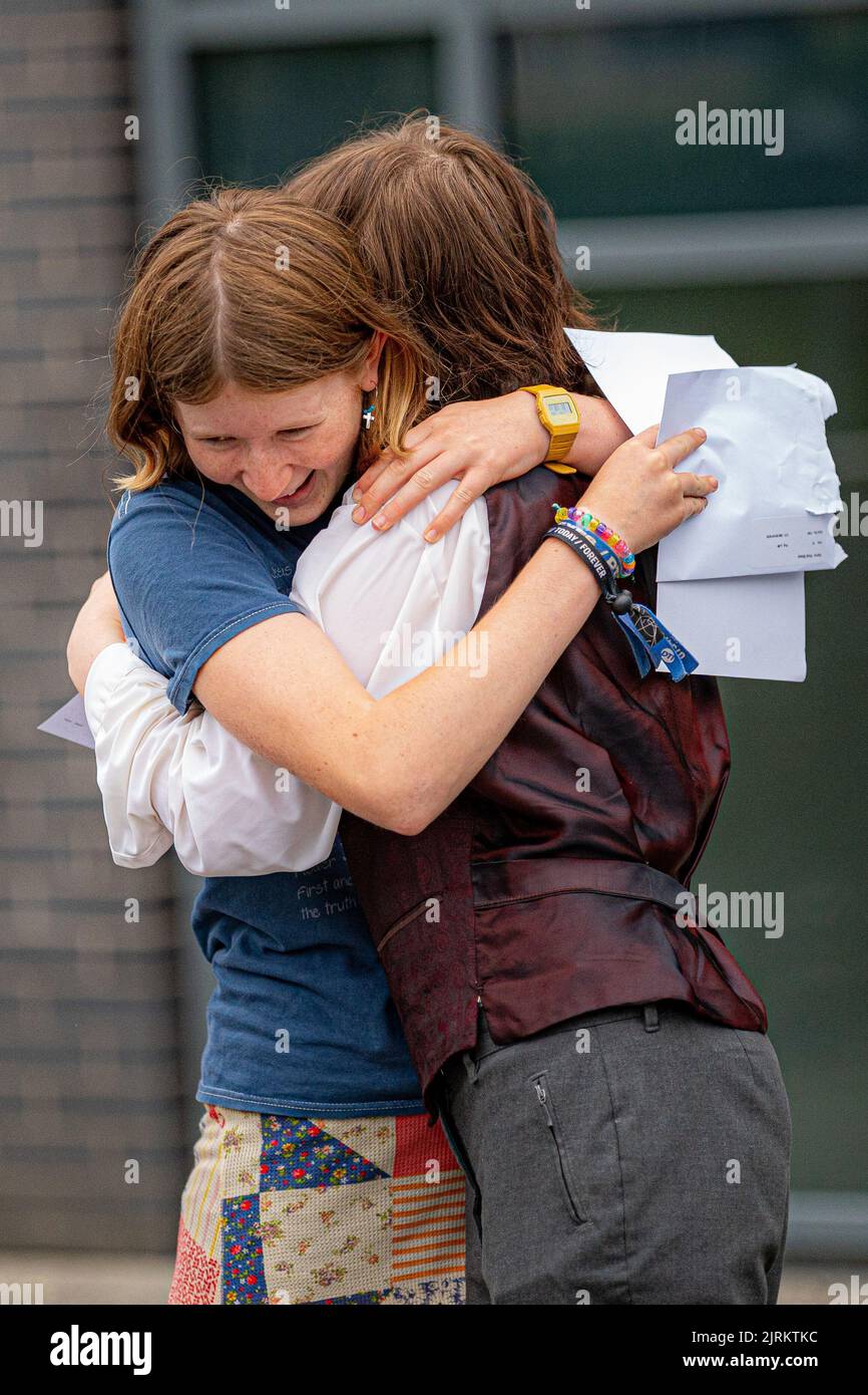 Friends Grace Ford, 16, left and Miriam McGrath, 16, right, hug as they ...