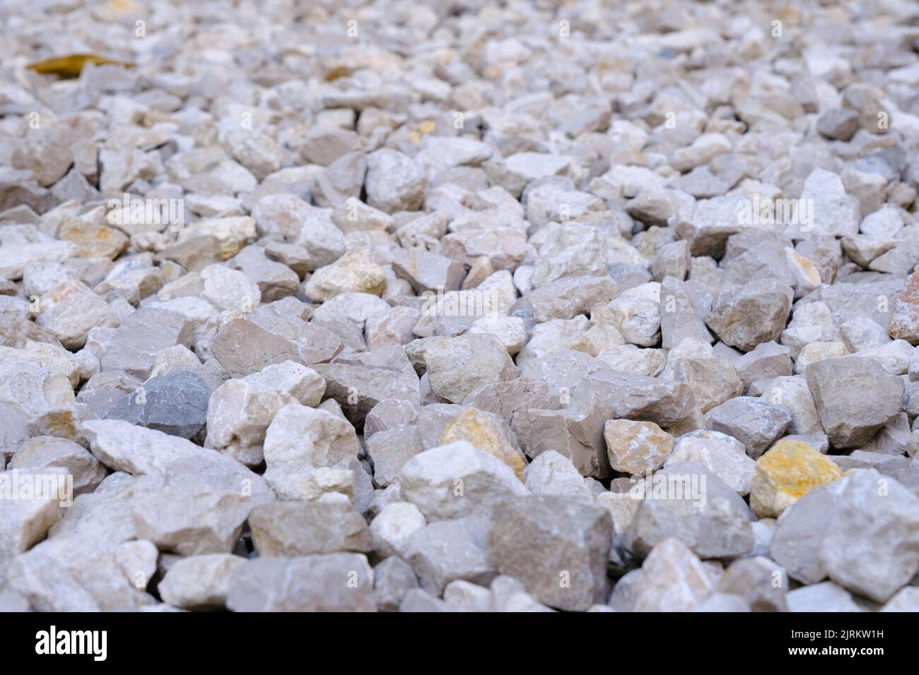 Close up of small white marble stones background, a pile of rocks ...