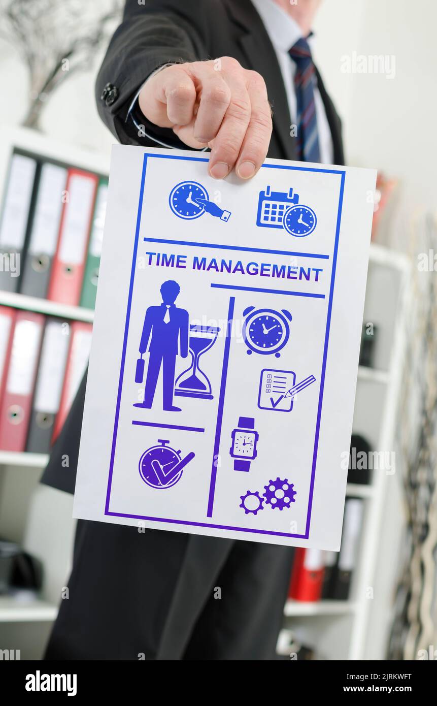 Paper showing time management concept held by a businessman Stock Photo ...