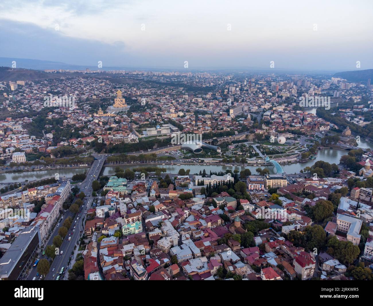Drone view of old city located near hills and river on summer day in ...