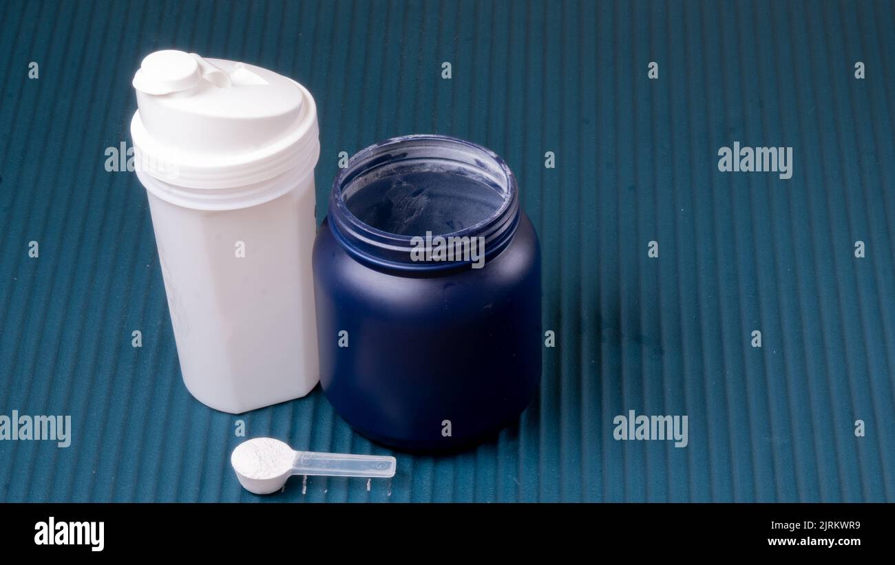 Shaker, a can of sports nutrition and a miser, a measuring spoon on the ...