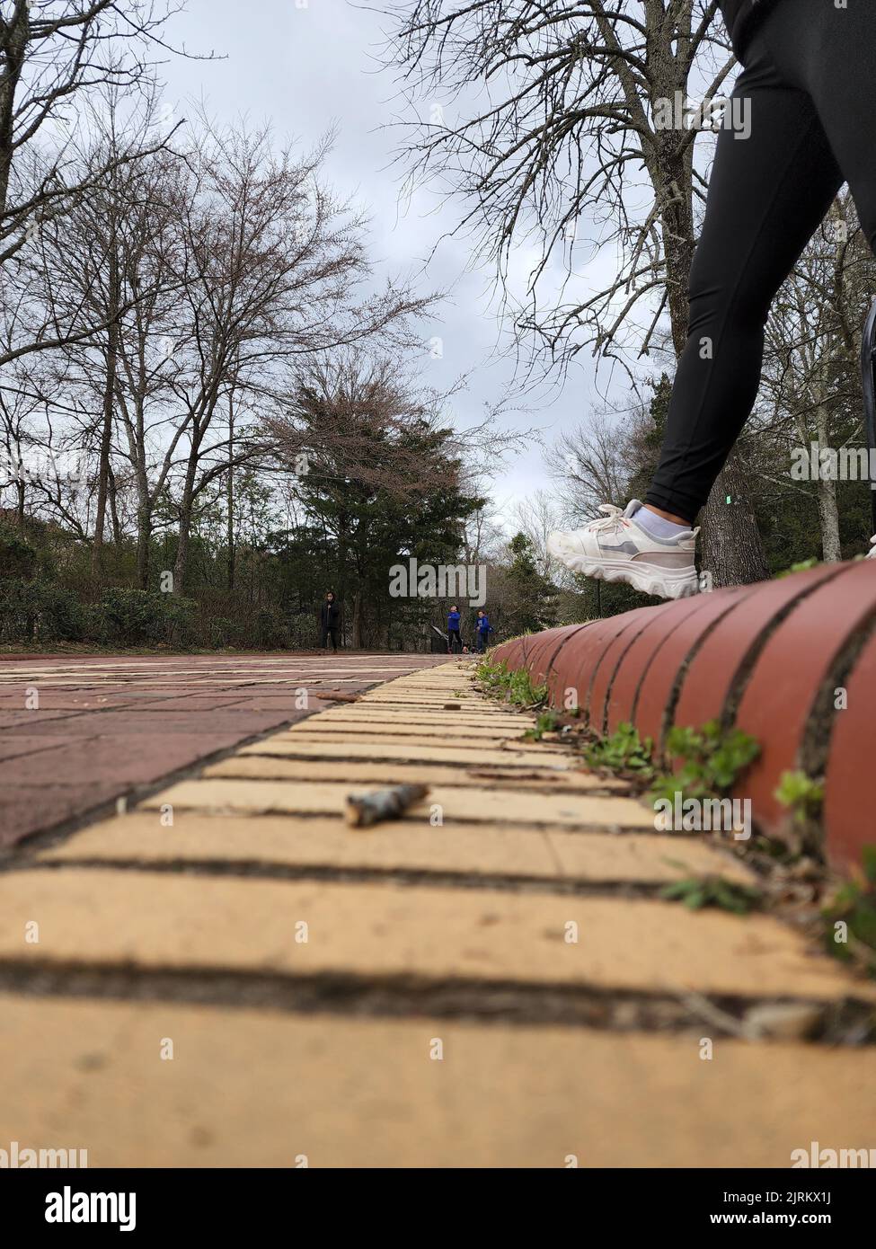 A man walling by the sidewalk Stock Photo - Alamy