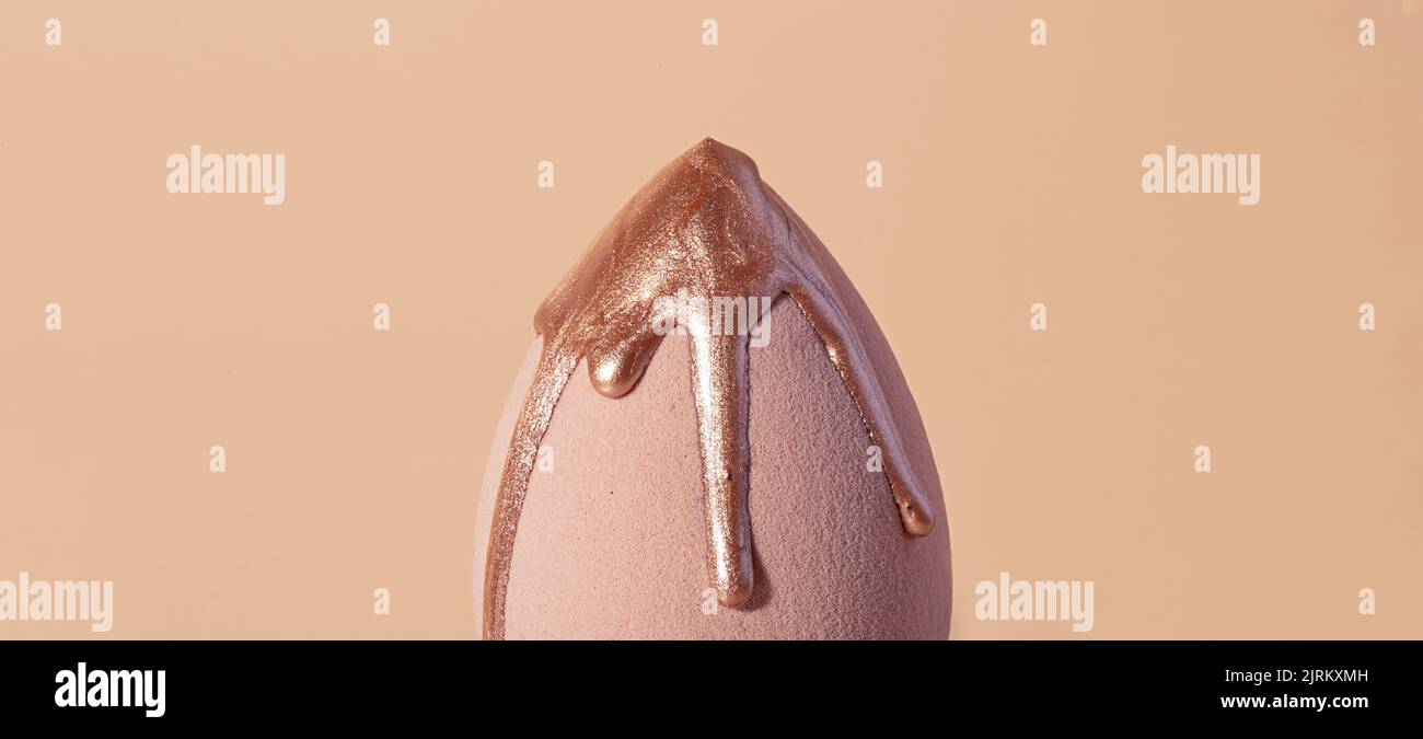 Closeup photography of beauty blender with dripping bronzer on it ...