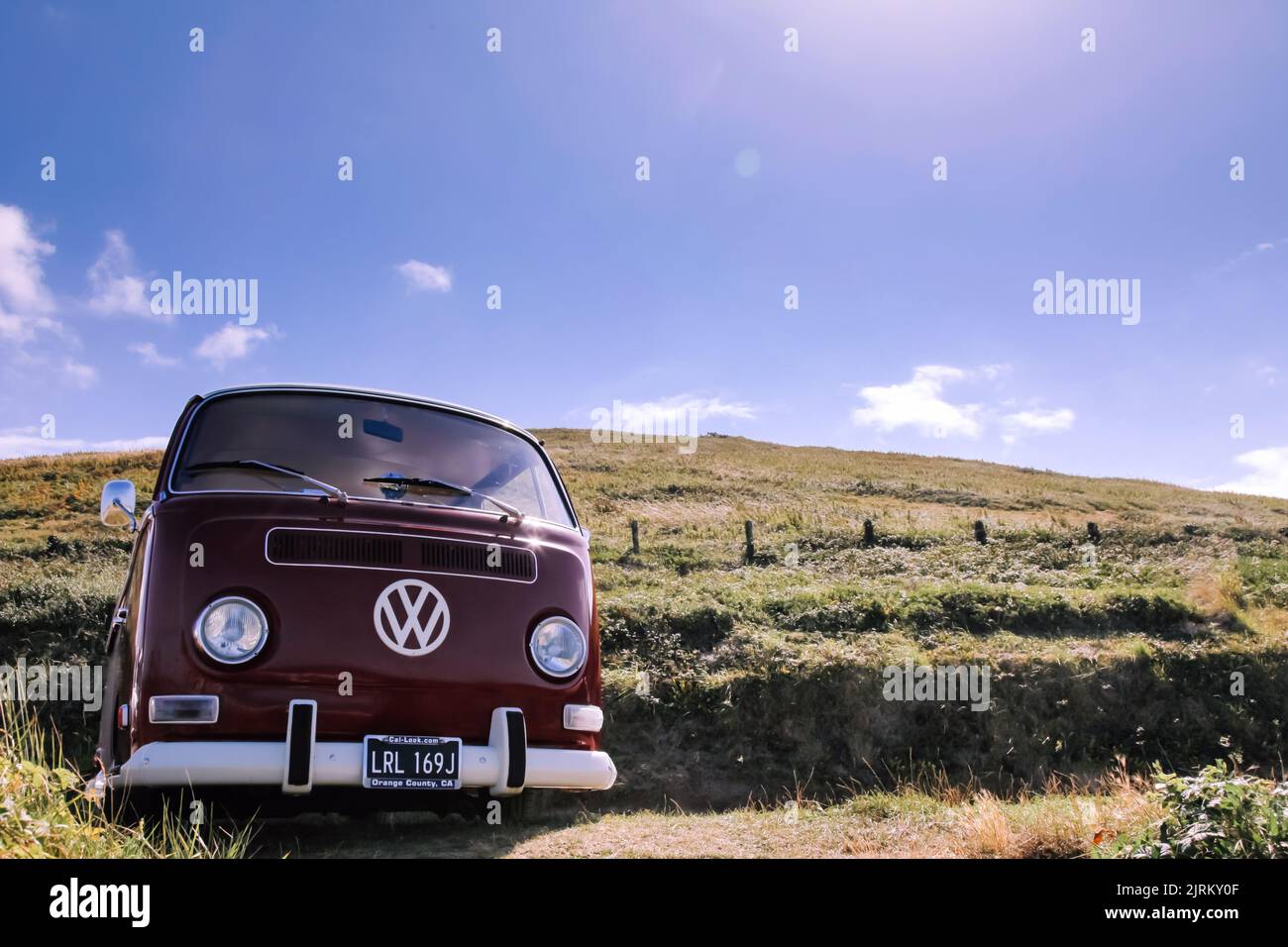 A VW Volkswagen Classic Campervan parked on the UK coast with blue sky ...