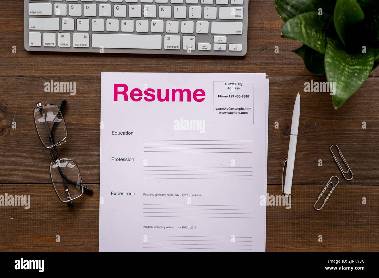 We are hiring. Resume application form on office table Stock Photo - Alamy