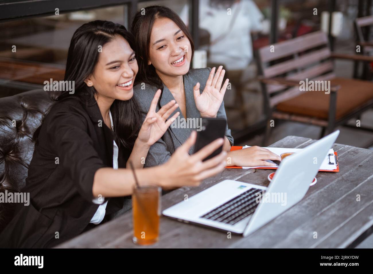 attractive asian female worker make a video call conference using ...