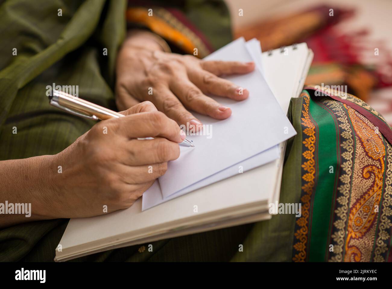 Hands of senior woman writing letter to relatives Stock Photo - Alamy