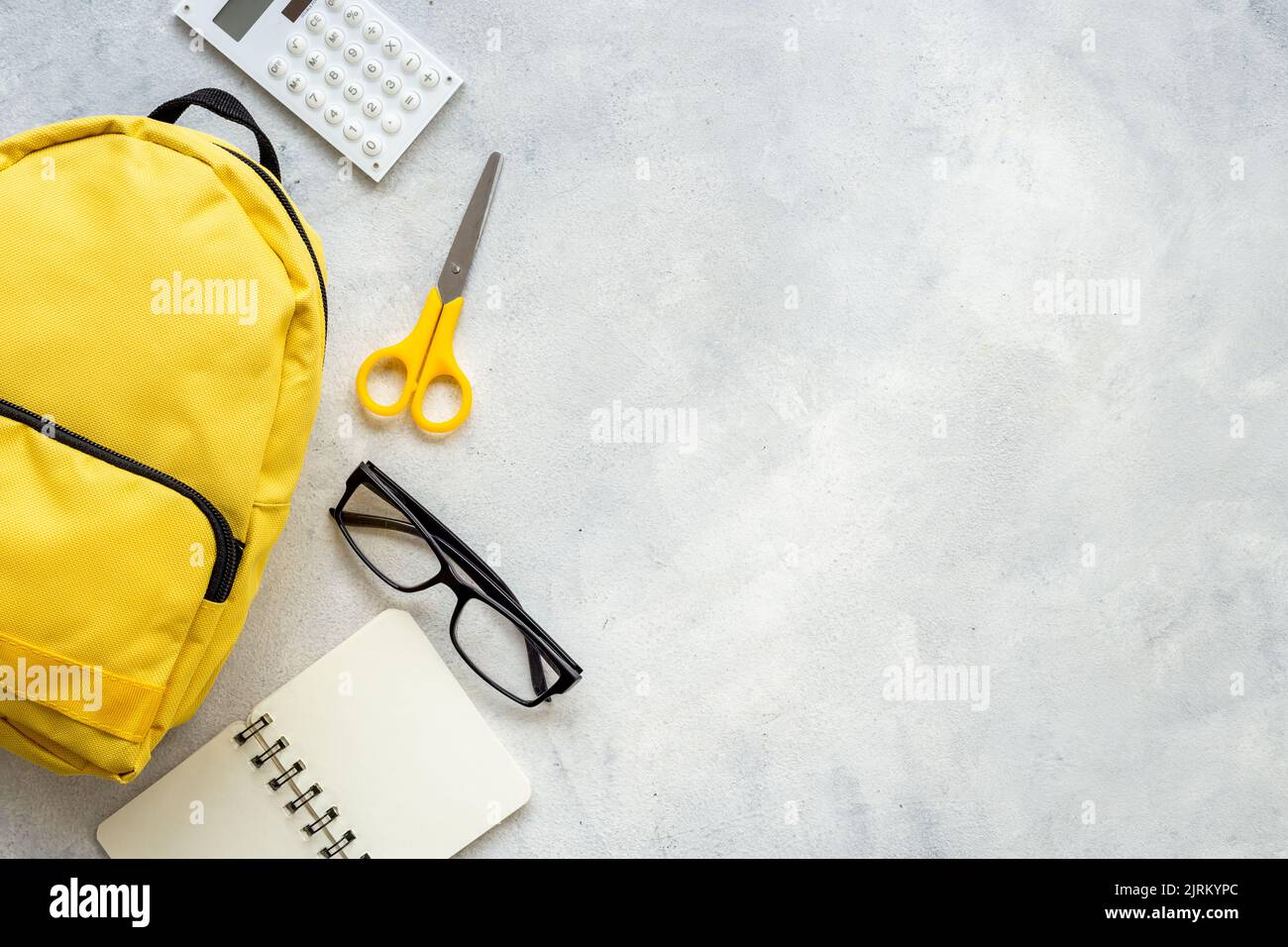 Yellow school backpack with student accessories. College and school ...