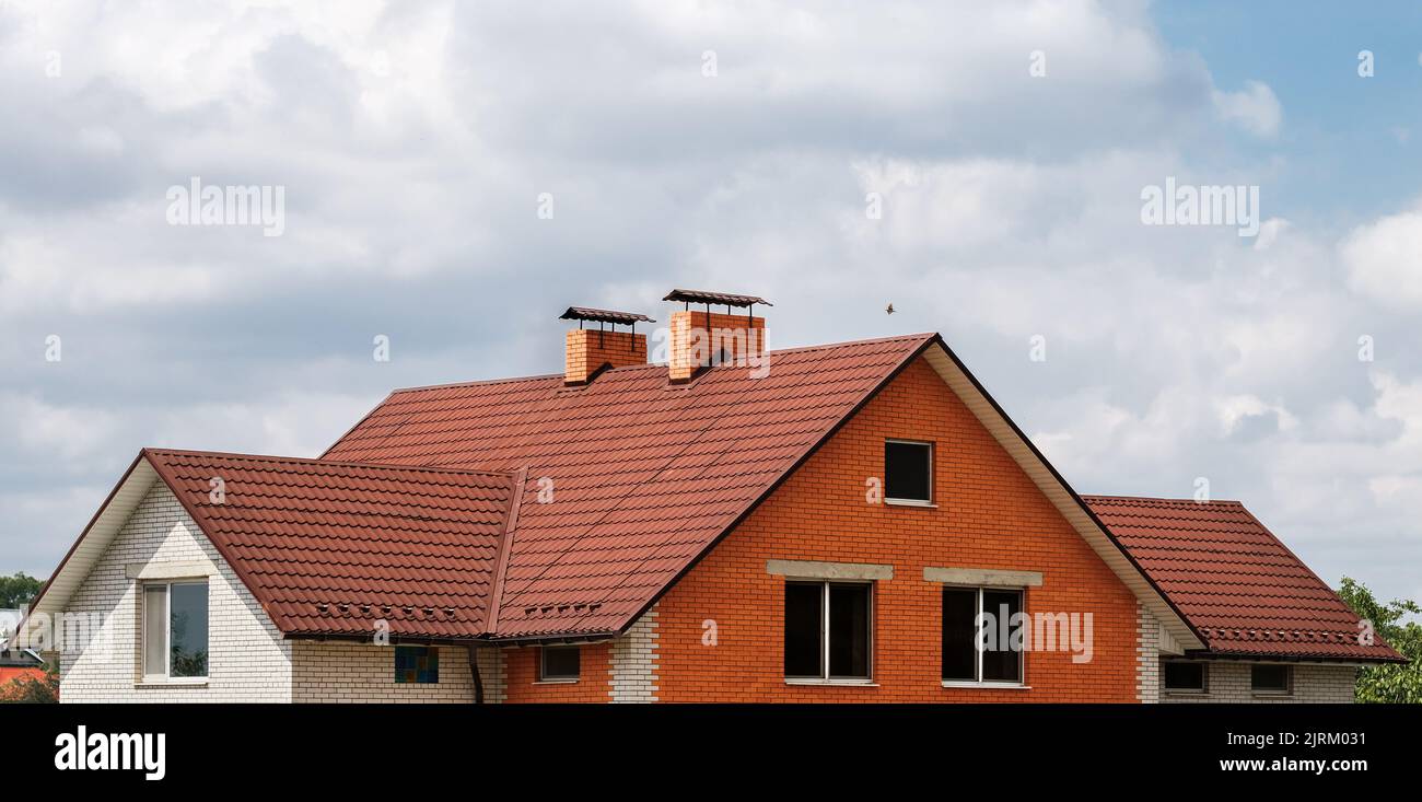 Roof made of light brown metal tile, metal roofing shingles and chimney ...