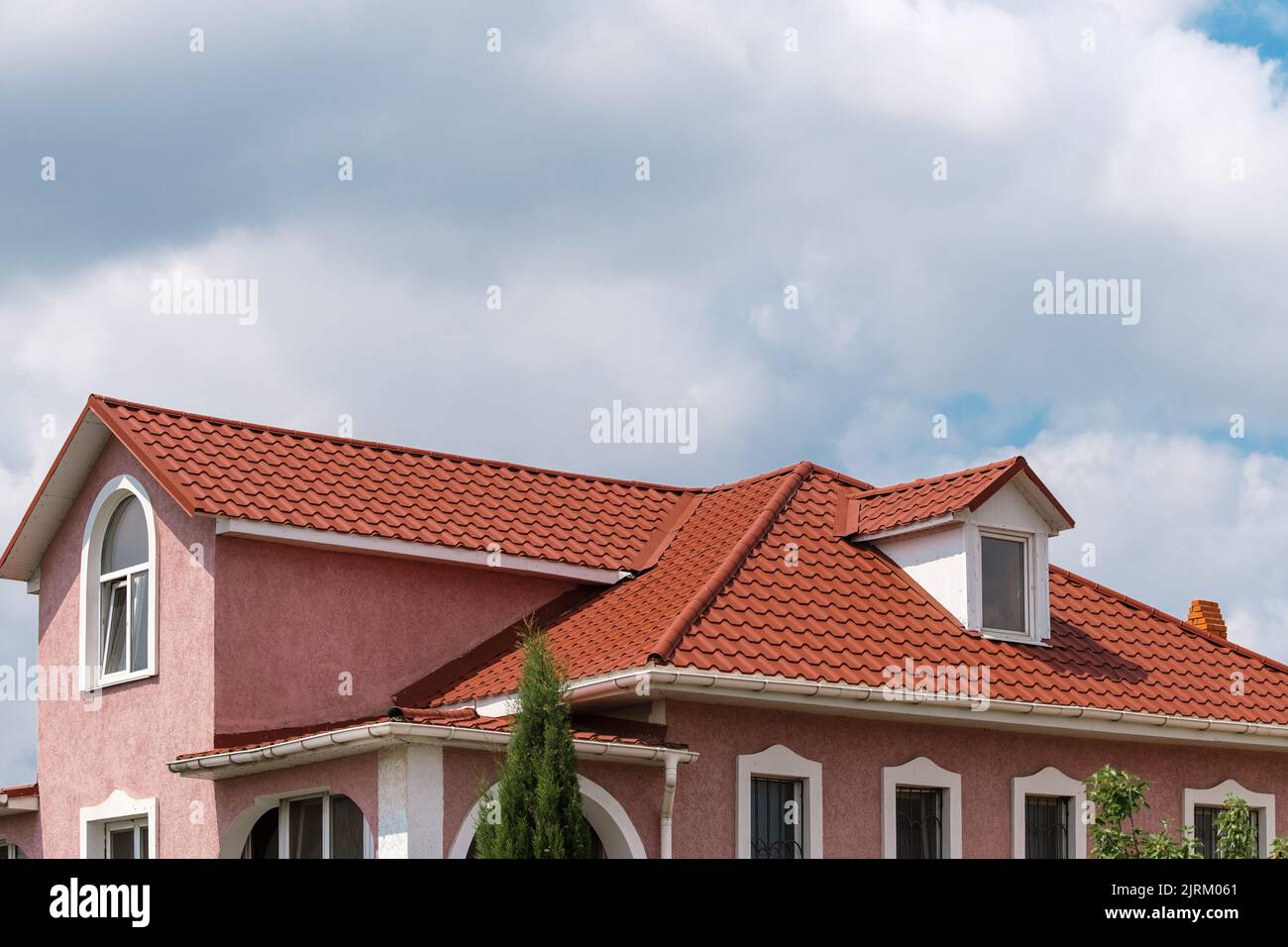 House with roof made of light brown red metal tile, metal roofing ...