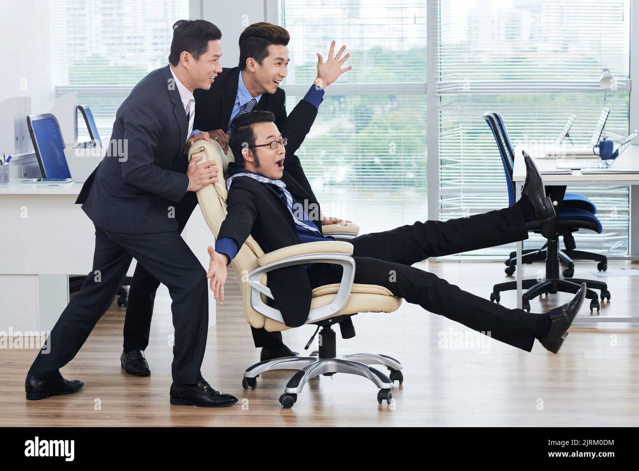 Having fun at spacious open plan office: Asian white collar workers ...