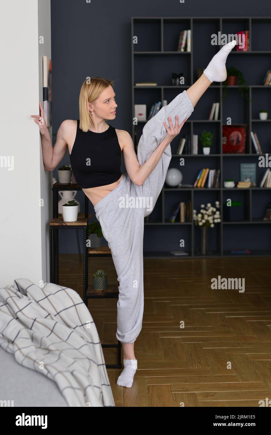Woman practicing lifting her leg high Stock Photo - Alamy