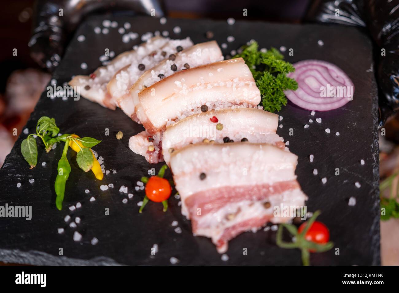 Smoked lard, bacon, half a piece, on a wooden dark craft background ...