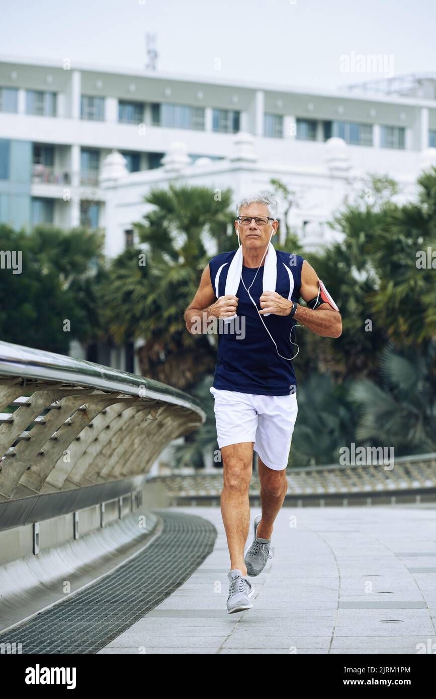 Healthy elderly aged man running outdoors in the morning Stock Photo ...