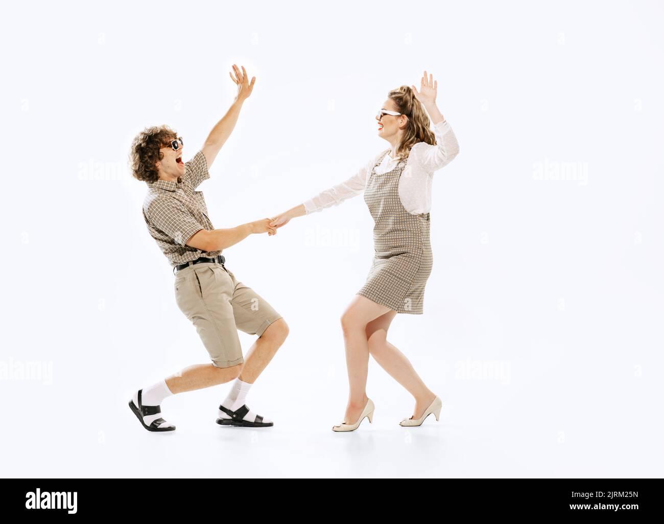 Excited young couple of dancers in vintage retro style outfits dancing ...