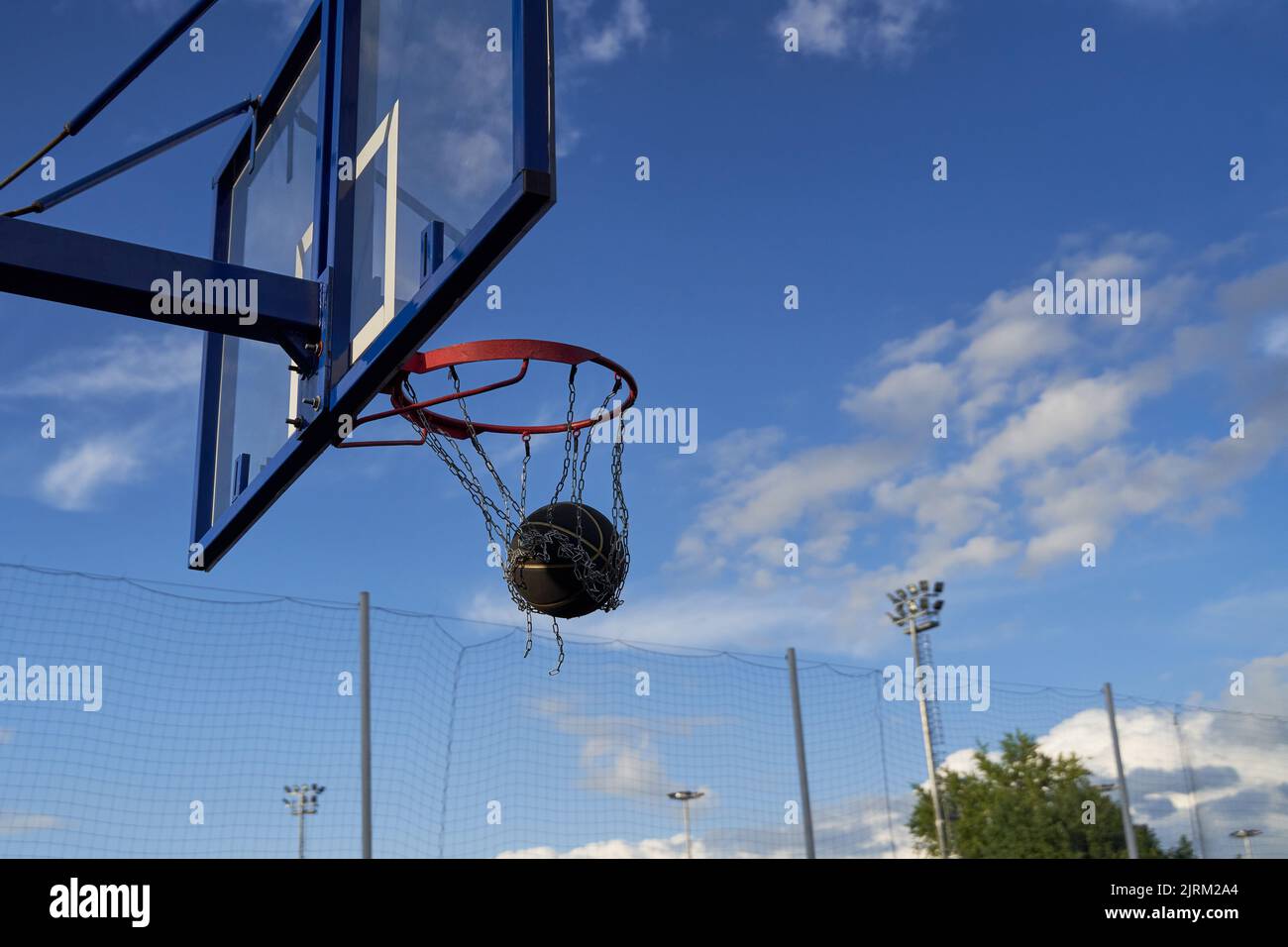 Street basketball ball falling into the hoop. Concept of success ...