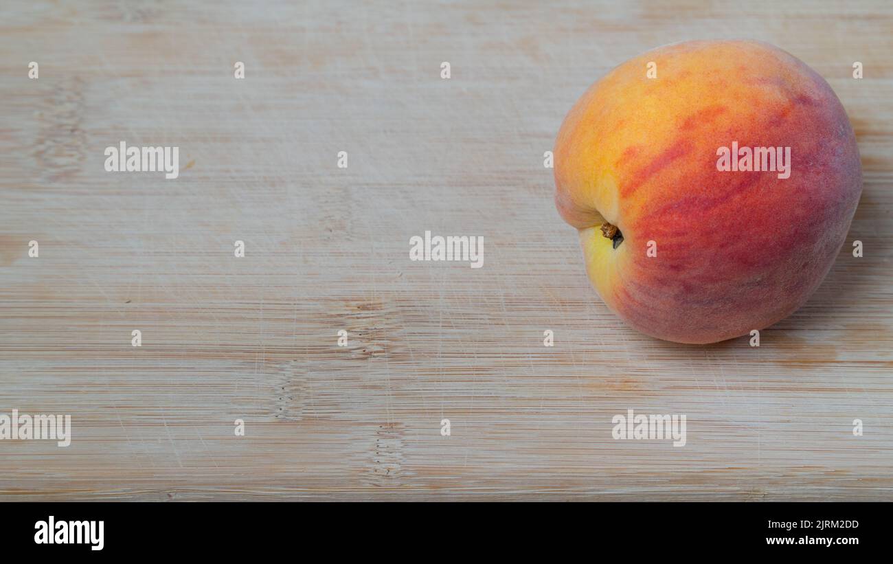 Peach fruit on a wooden background with space for text Stock Photo - Alamy