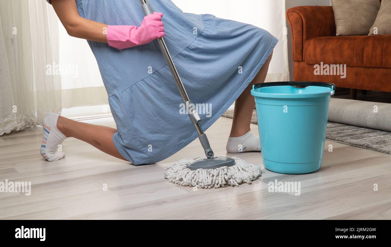Woman with a mop and a bucket in the pose of a rock star Stock Photo ...