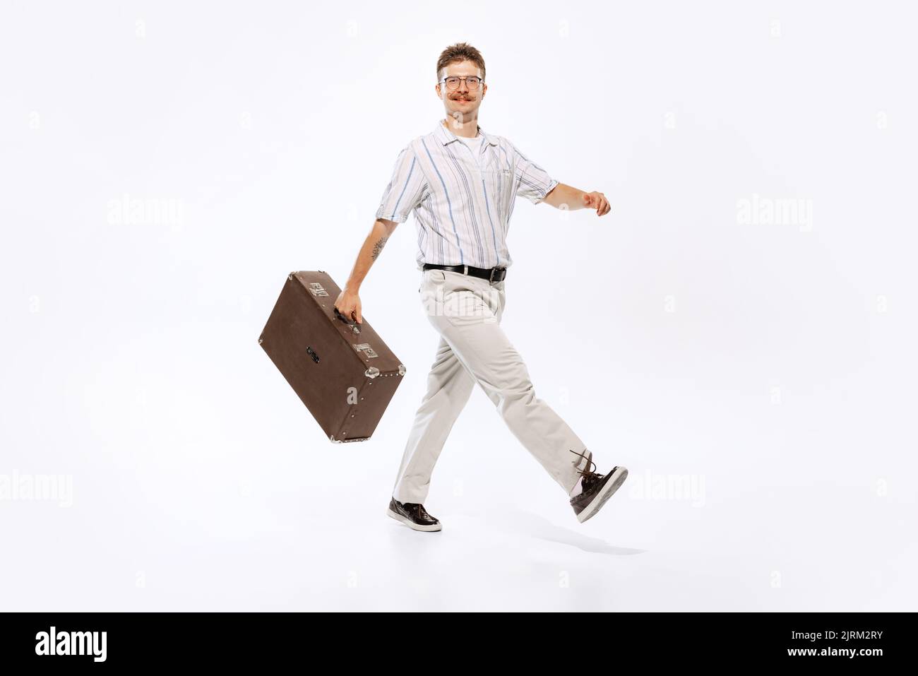 Portrait of young man, businessman dressed in suit in 50s, 60s fashion ...