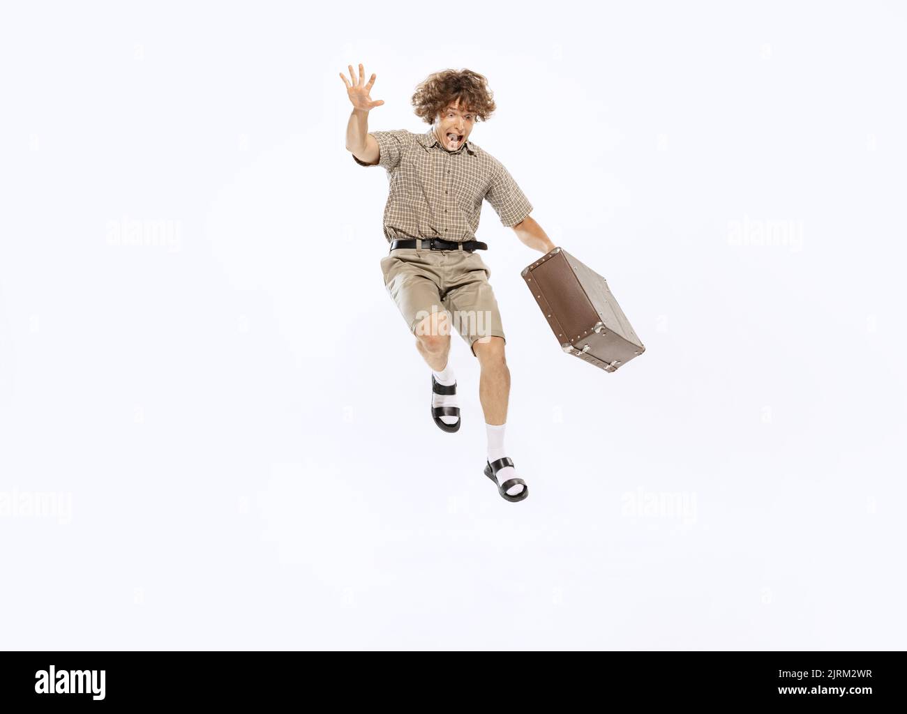 Portrait of young man in 50s, 60s fashion style clothes running ...