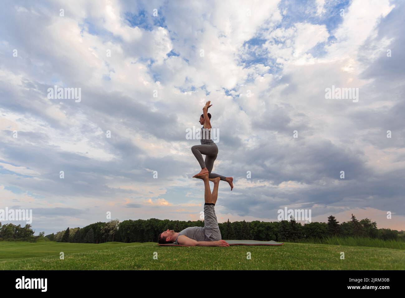 Strong acrobatic woman lifting man hi-res stock photography and images ...