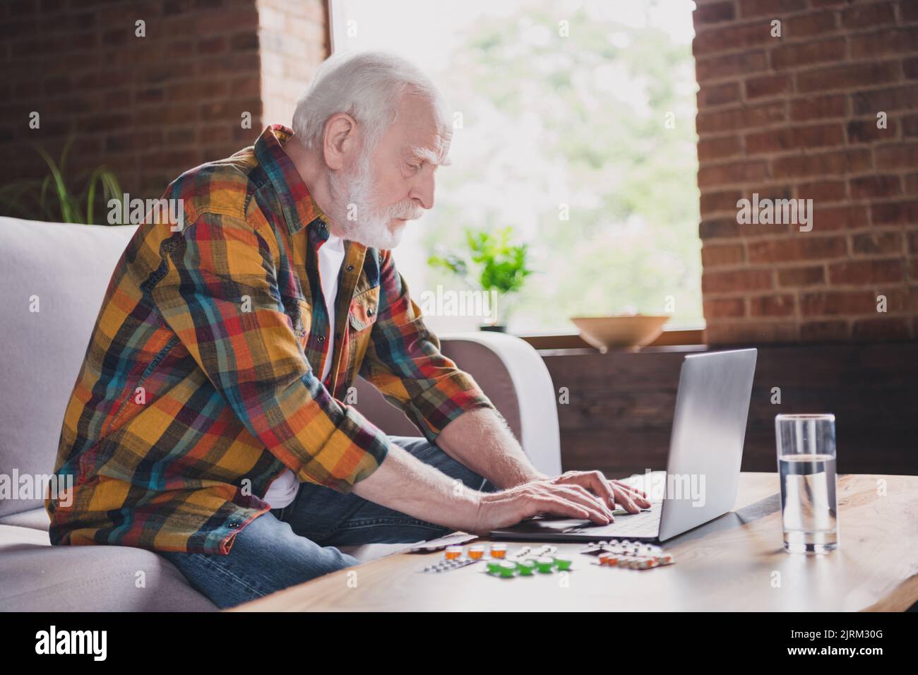 Photo of lonely busy man pensioner wear checkered shirt typing modern ...