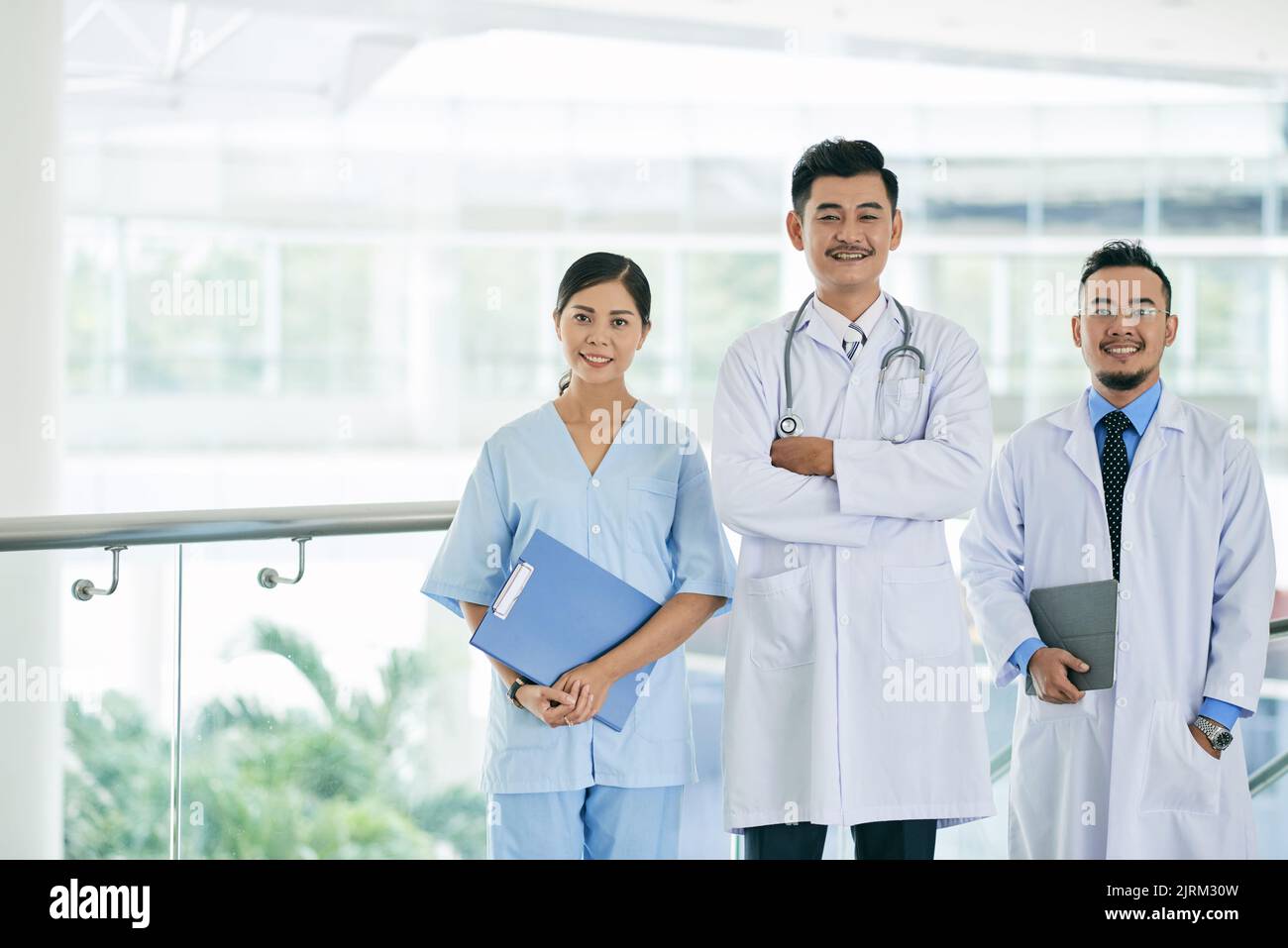 Vietnamese hospital workers smiling and looking at camera Stock Photo ...