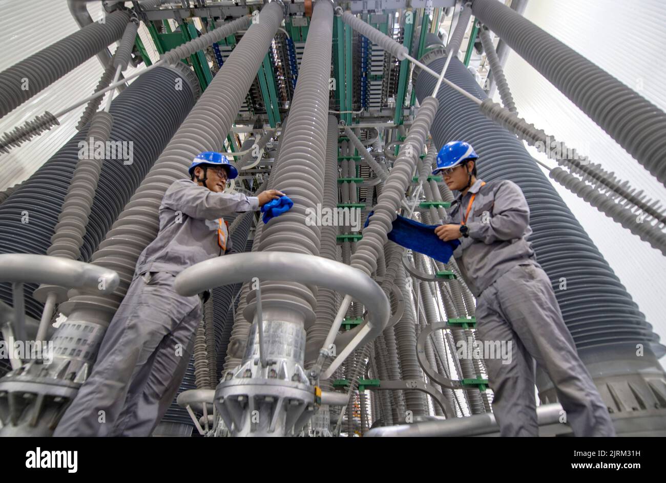 BEIJING, CHINA - AUGUST 25, 2022 - Maintenance workers clean substation ...