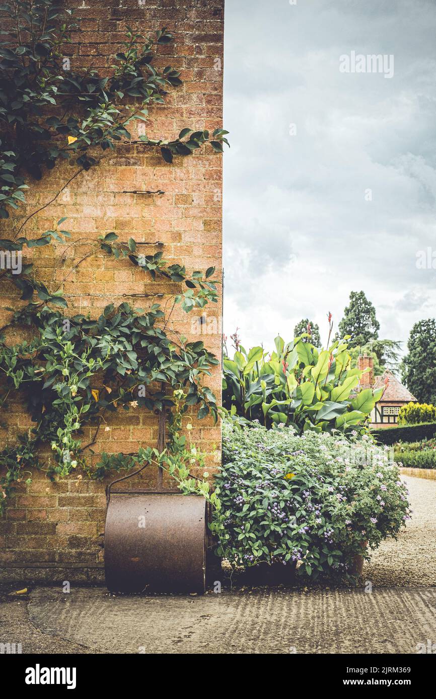 Garden roller leaned up against a wall at Eythrope Gardens on the ...