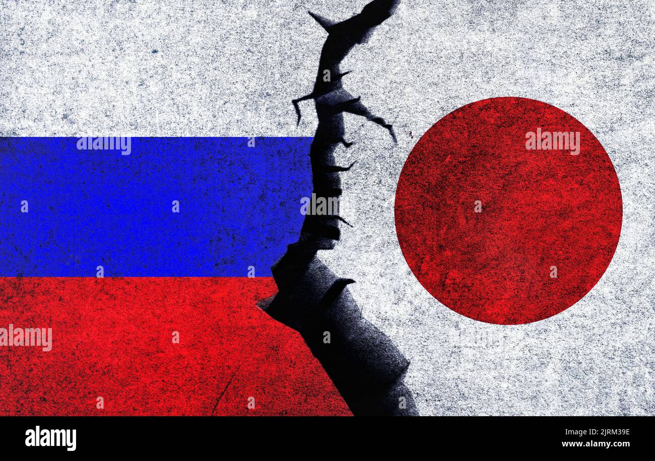 Russia vs Japan concept flags on a wall with a crack. Japan and Russia ...