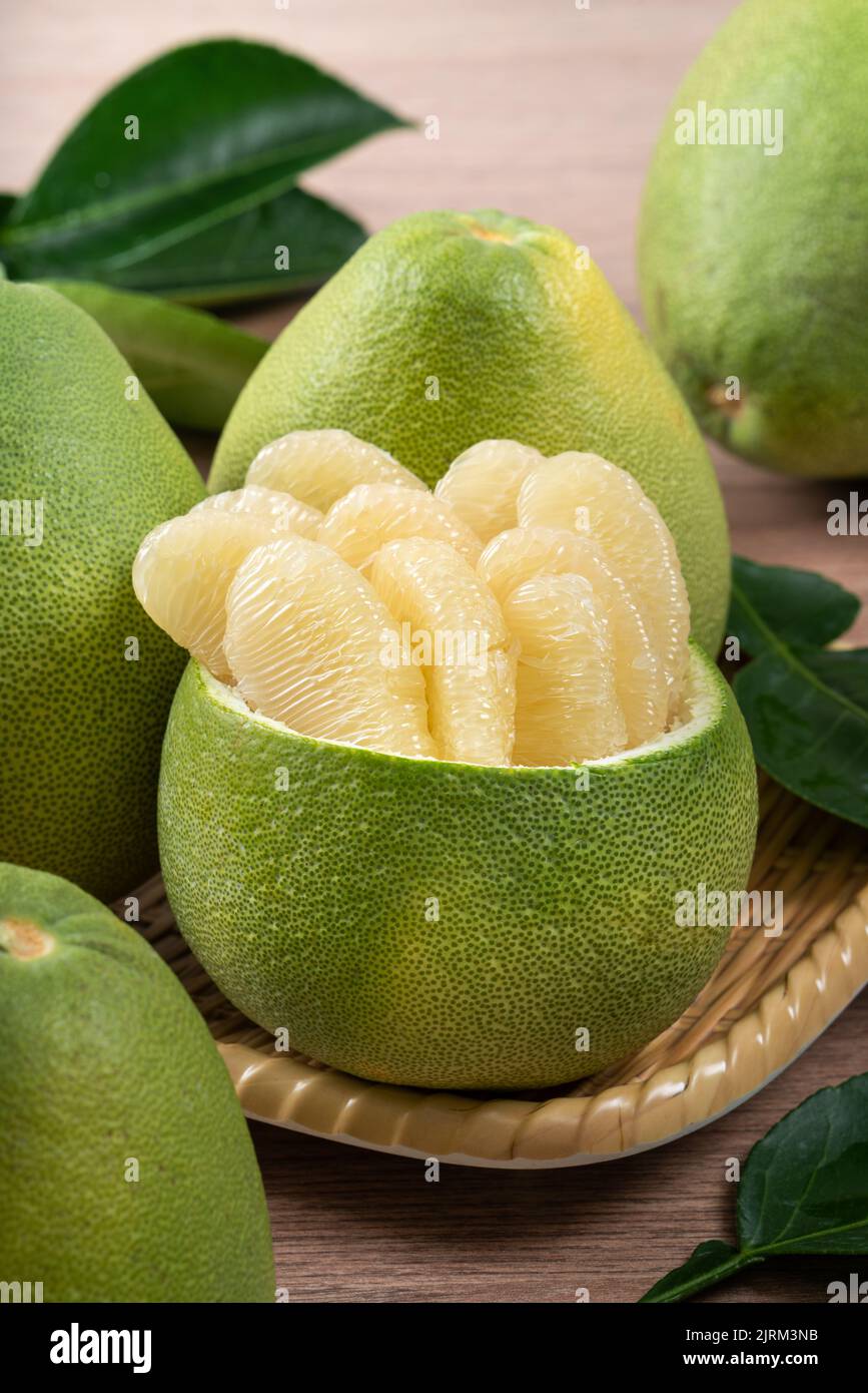 Close up of fresh peeled pomelo on wooden table background for Mid ...