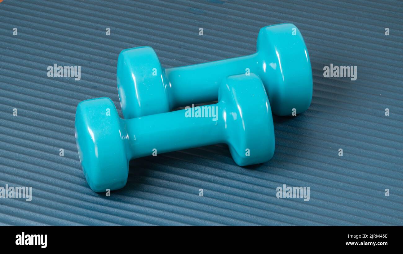 Two blue dumbbells on the workout mat - sports background Stock Photo ...