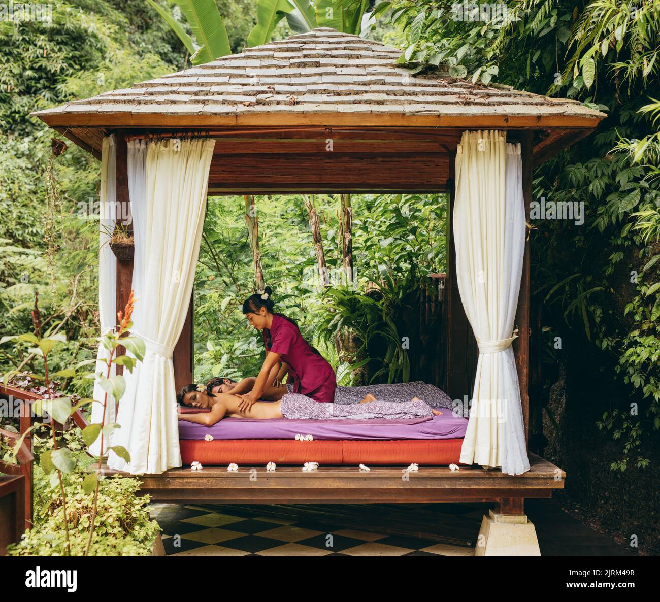 Shot Of Young Man And Woman Receiving Massage At Health Spa In Luxury Resort Couple At Outdoor