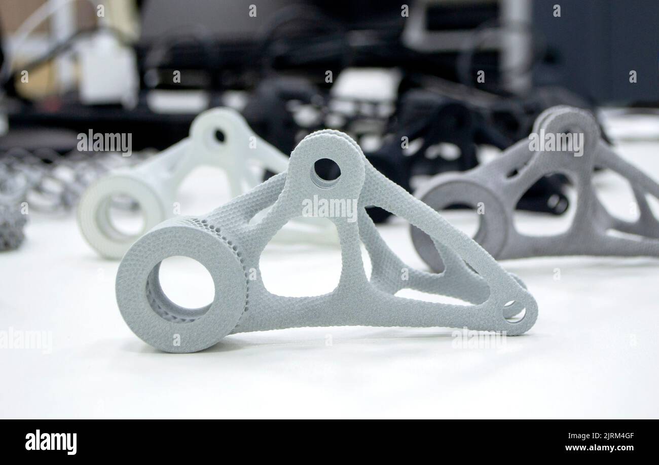 Black white gray models printed on 3D printer in laboratory office. Objects printed on 3D ...